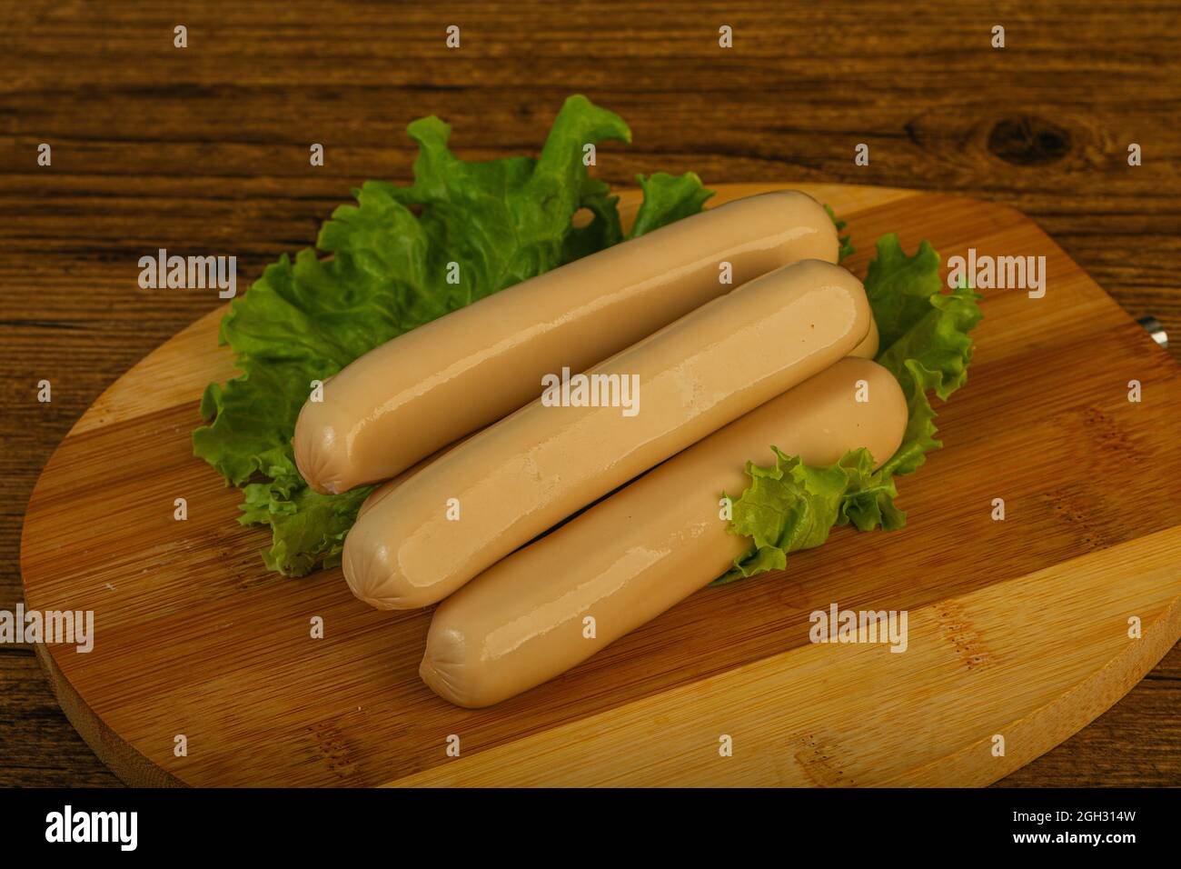 Chicken white sausage with salad leaves Stock Photo - Alamy