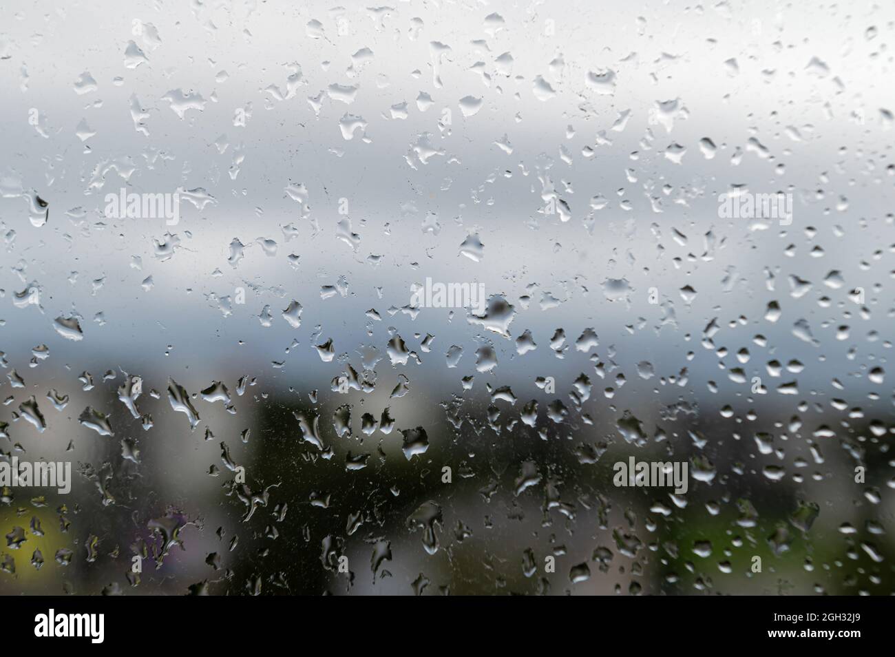 raindrops on window glass, selective focus, rainy city background ...