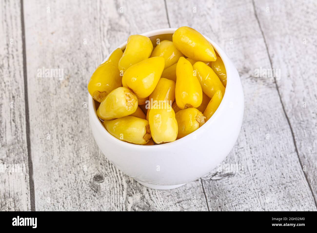 Pickled Yellow spicy mini pepper in the bowl Stock Photo - Alamy