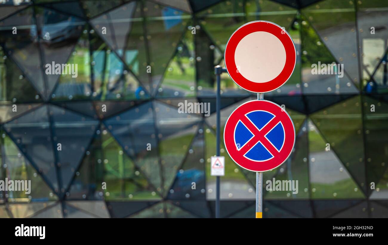 the road signs on the defocused urban background, traffic signs at city ...