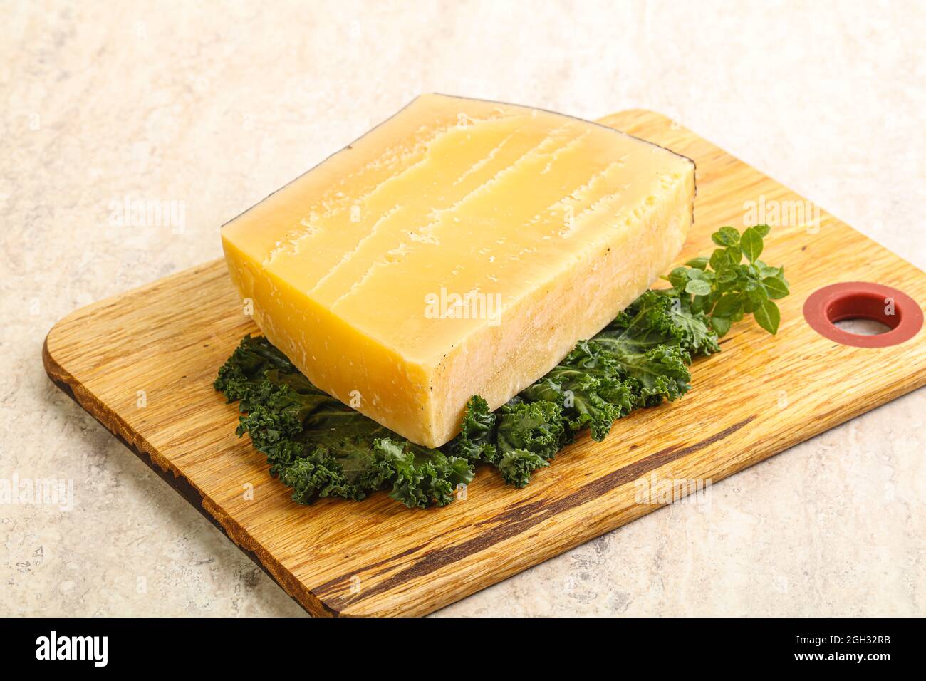 Hard Parmesan cheese piece over board Stock Photo - Alamy