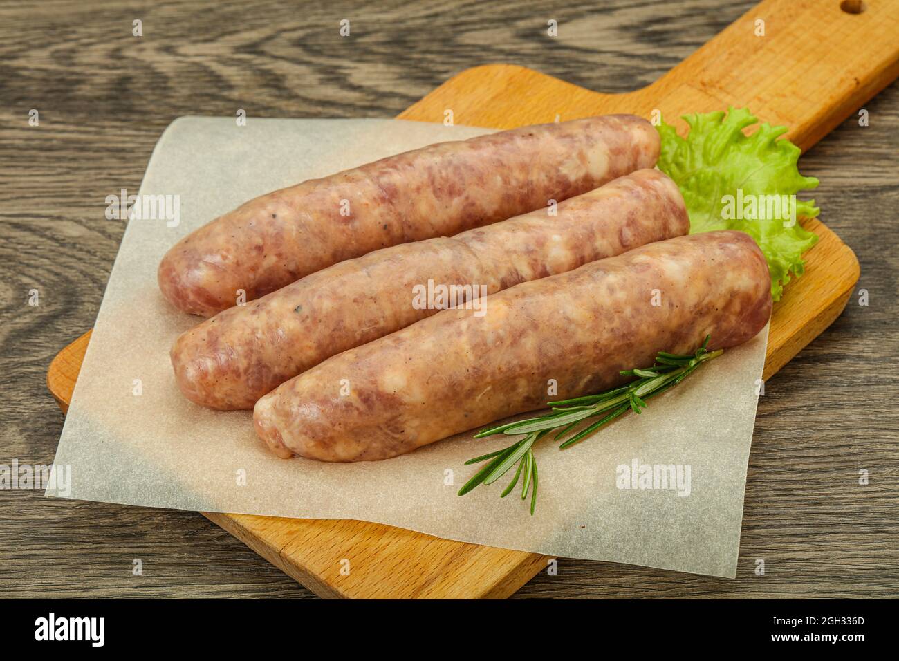 Raw pork meat sausages for grill served rosemary Stock Photo - Alamy