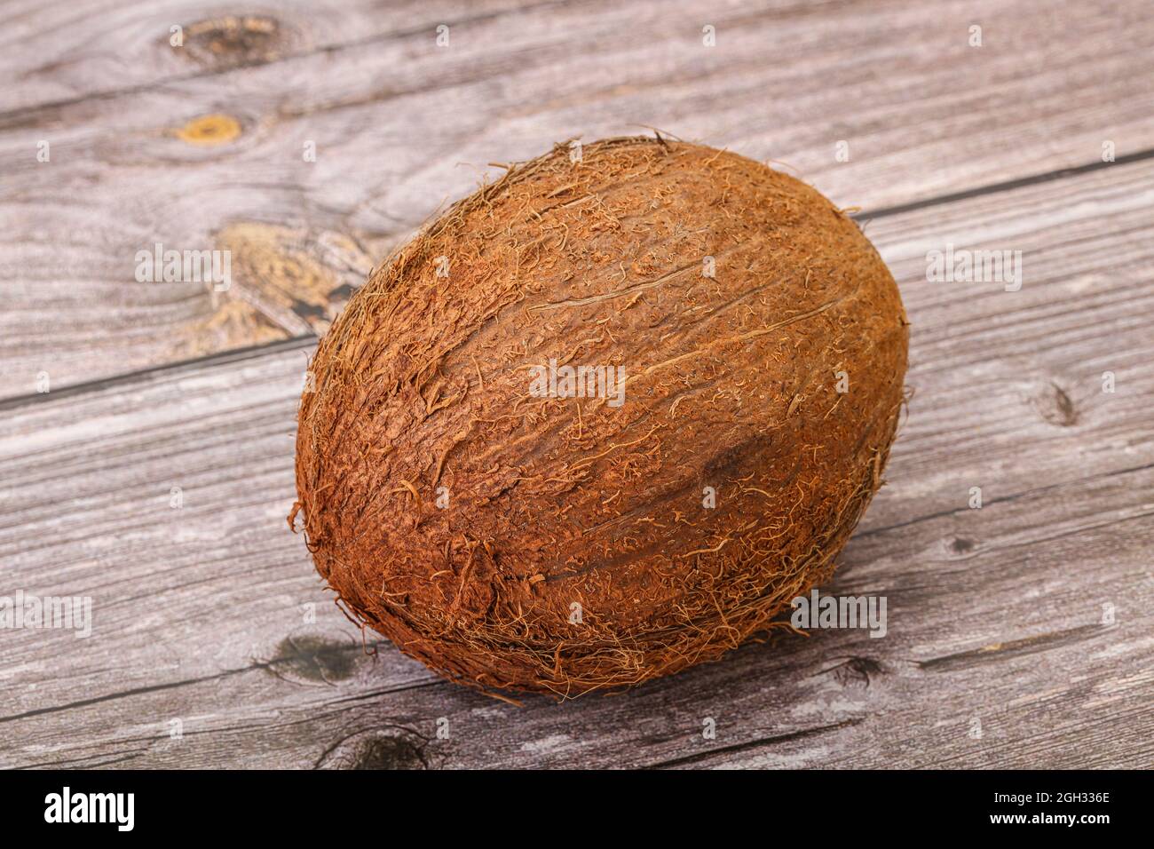 Tropical brown coconut over background isolated Stock Photo - Alamy