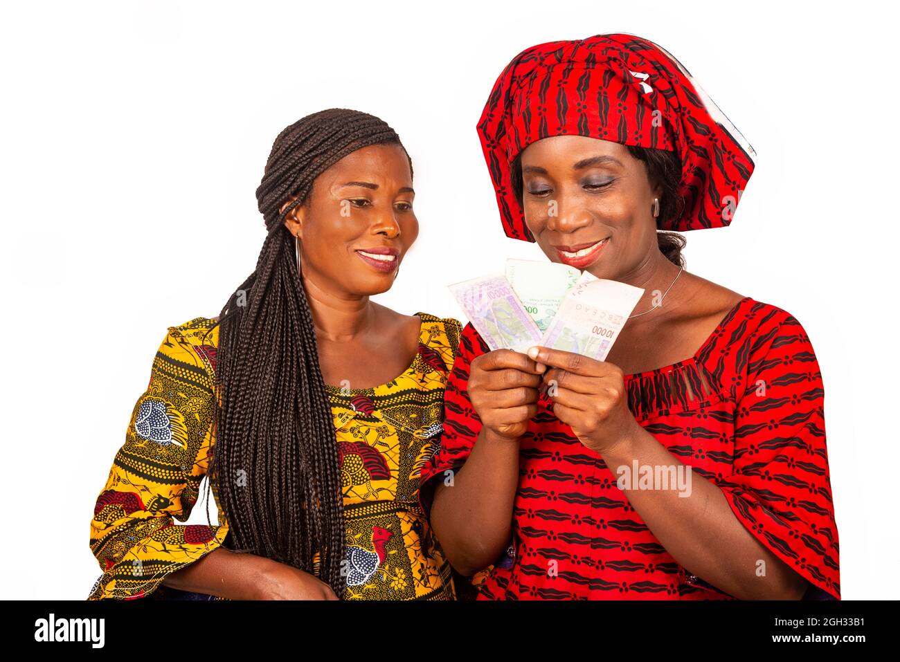 two beautiful businesswomen standing in traditional dress on white ...