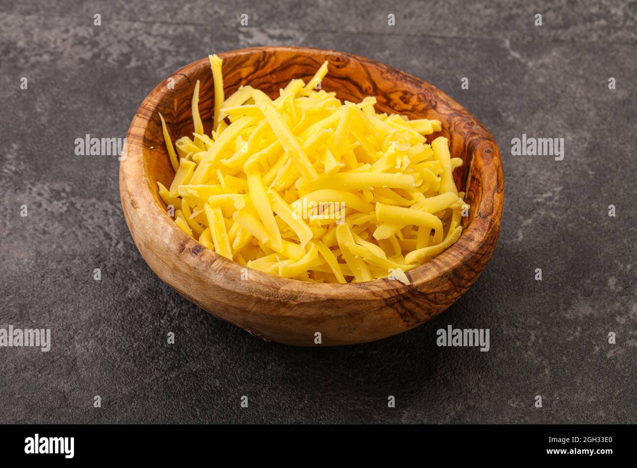Shredded yellow cheese in the bowl for cooking Stock Photo - Alamy