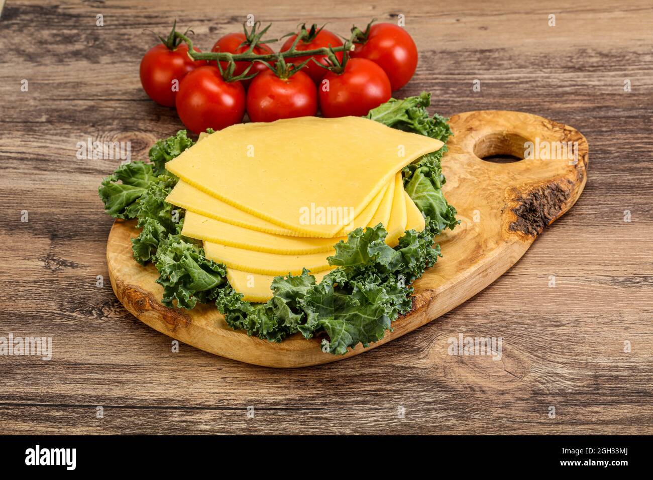 Sliced Gauda cheese snack over board Stock Photo - Alamy