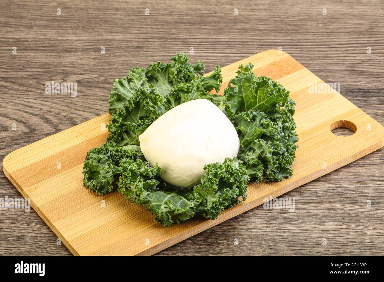 Soft Italian mozzarella cheese over board Stock Photo - Alamy
