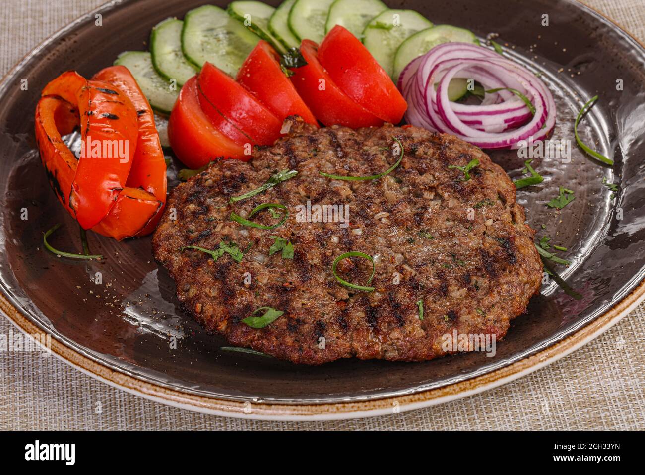 Grilled Beef cutlet with vegetables served onion Stock Photo - Alamy