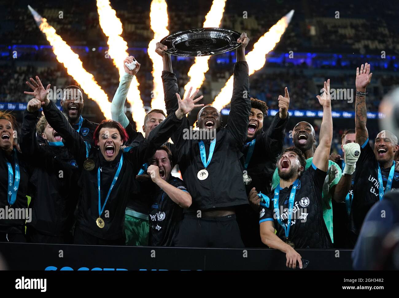 World XI's Usain Bolt lifts the trophy after winning the SoccerAid for ...