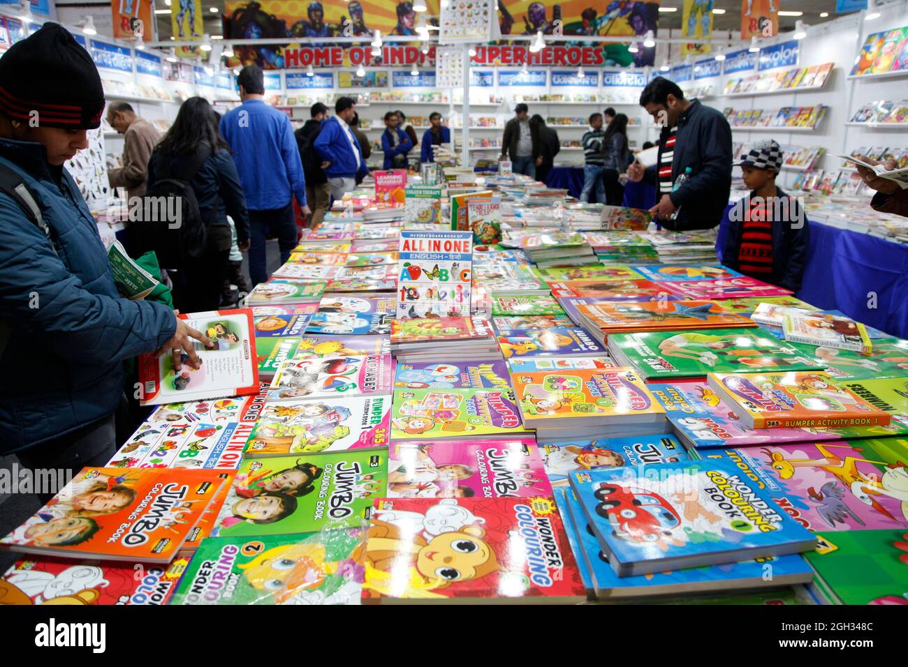 Visitors inspect and buy the books displayed at a book fair in New ...