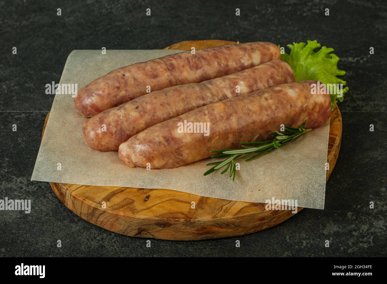 Raw pork meat sausages for grill served rosemary Stock Photo - Alamy