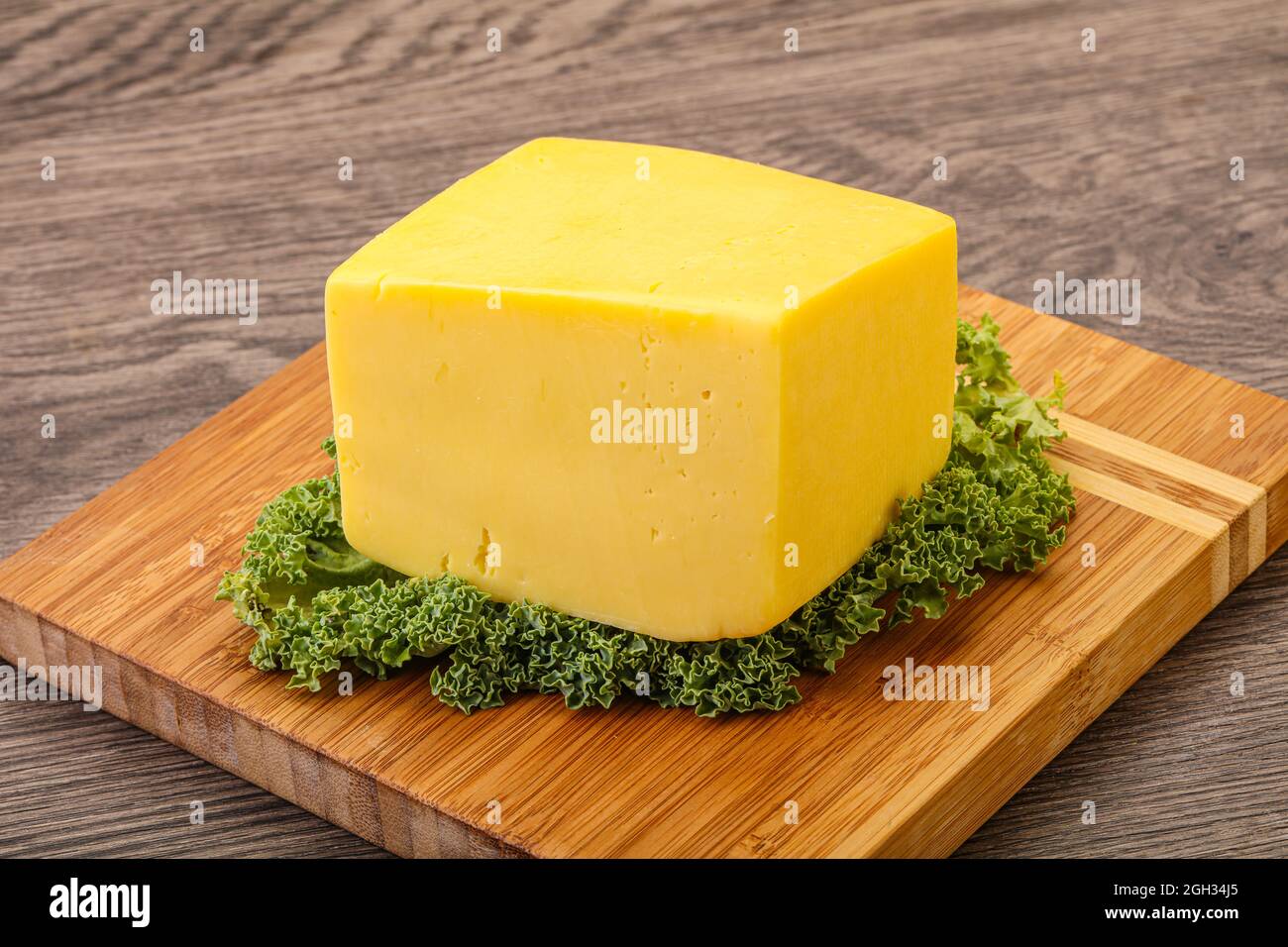 Yellow tilsiter cheese dairy product brick Stock Photo - Alamy
