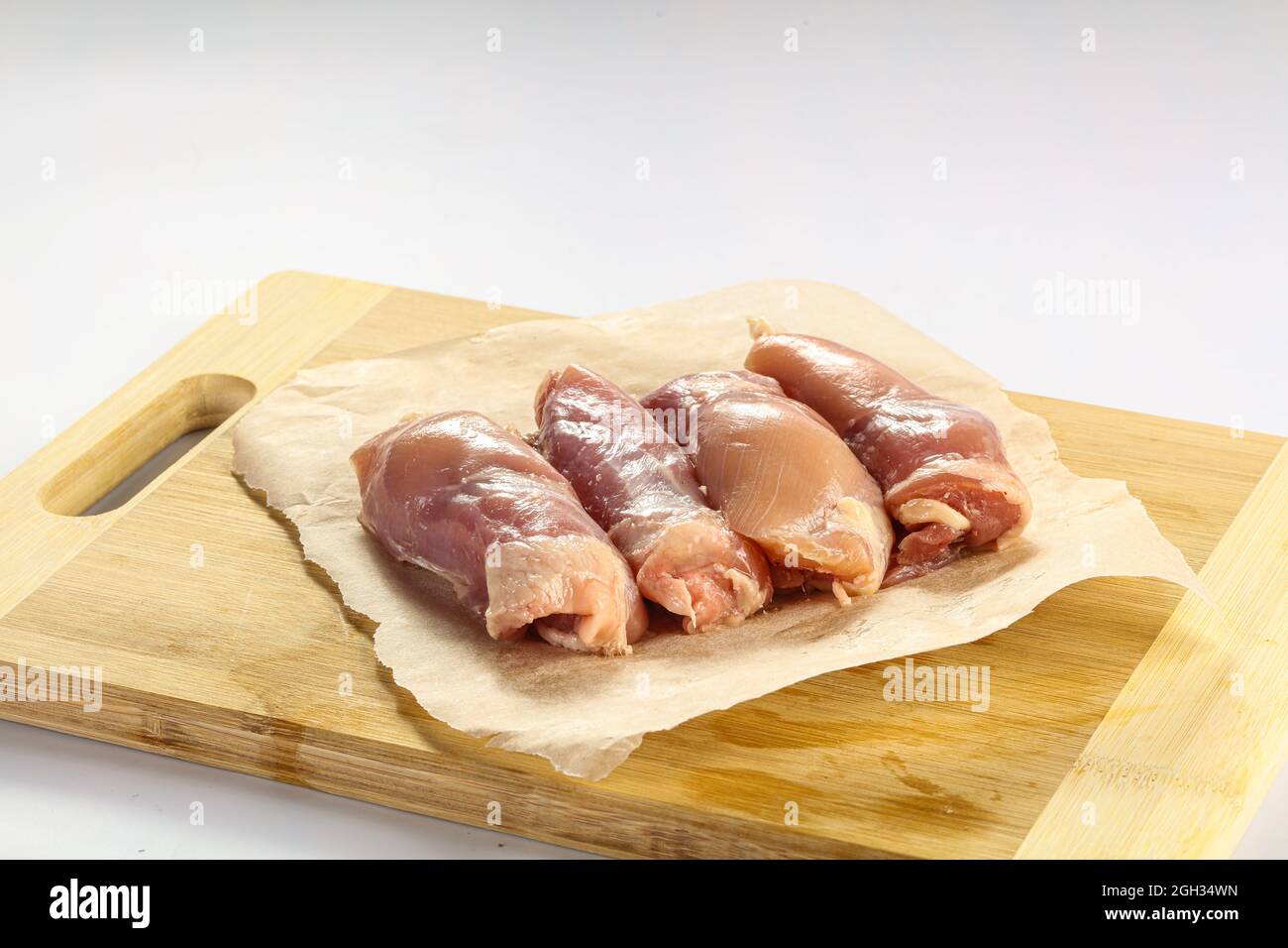 Raw chicken leg fillet over board isolated Stock Photo - Alamy