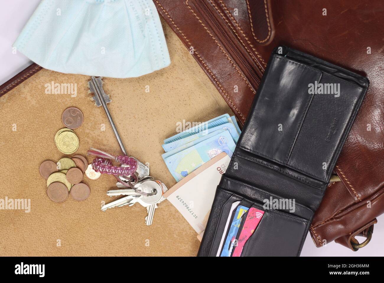 Overhead shot of an open male leather shoulder bag with contents of ...