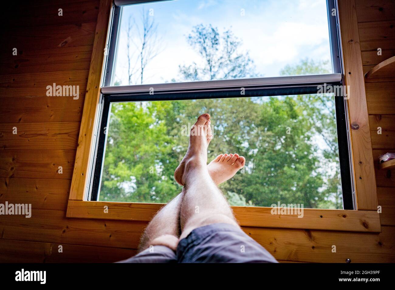 legs on an opened window Stock Photo - Alamy