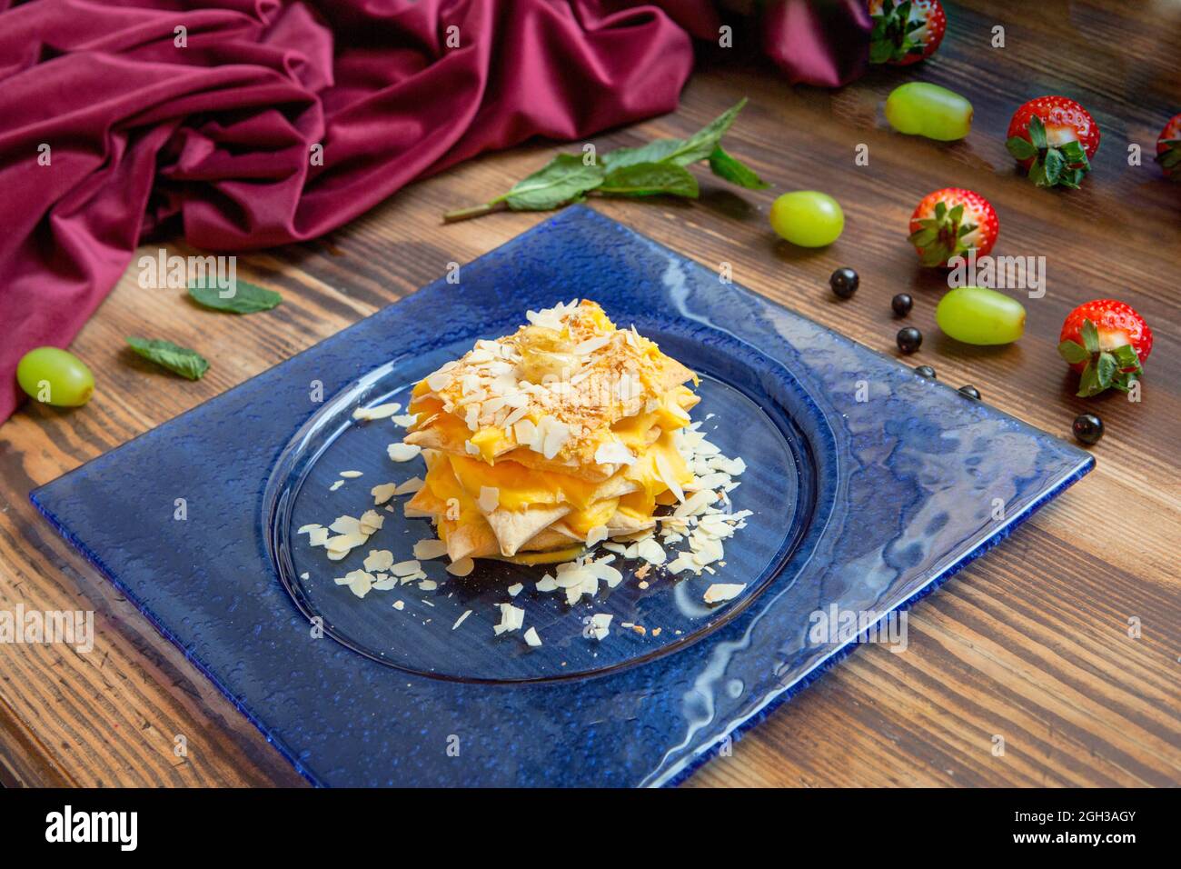 Dessert napoleon sprinkled with almonds and tea in the composition ...