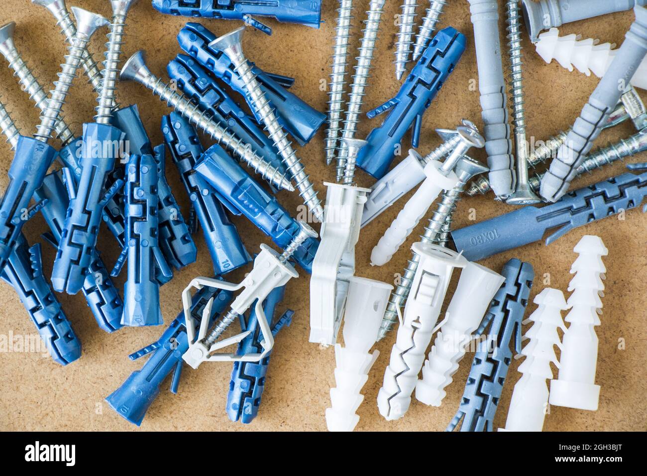 Wall plugs and screws on the brown background Stock Photo - Alamy