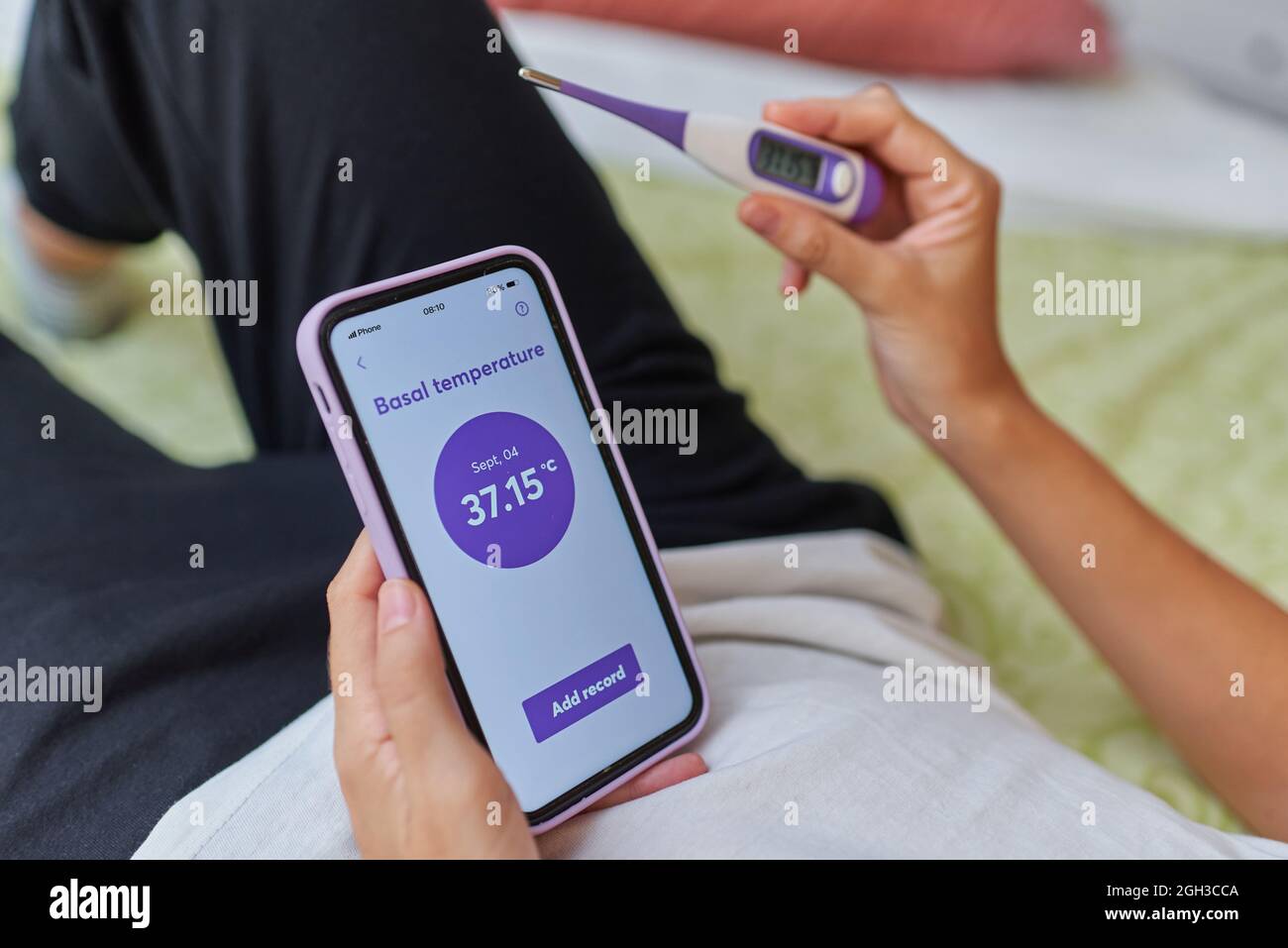Close up of a woman's hands taking her basal temperature Stock Photo ...