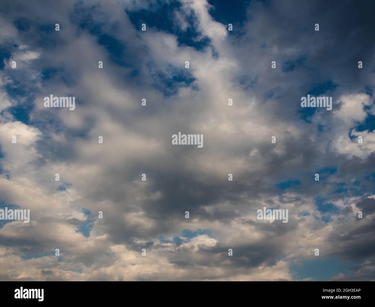 dramatic gray clouds in a blue sky Stock Photo - Alamy