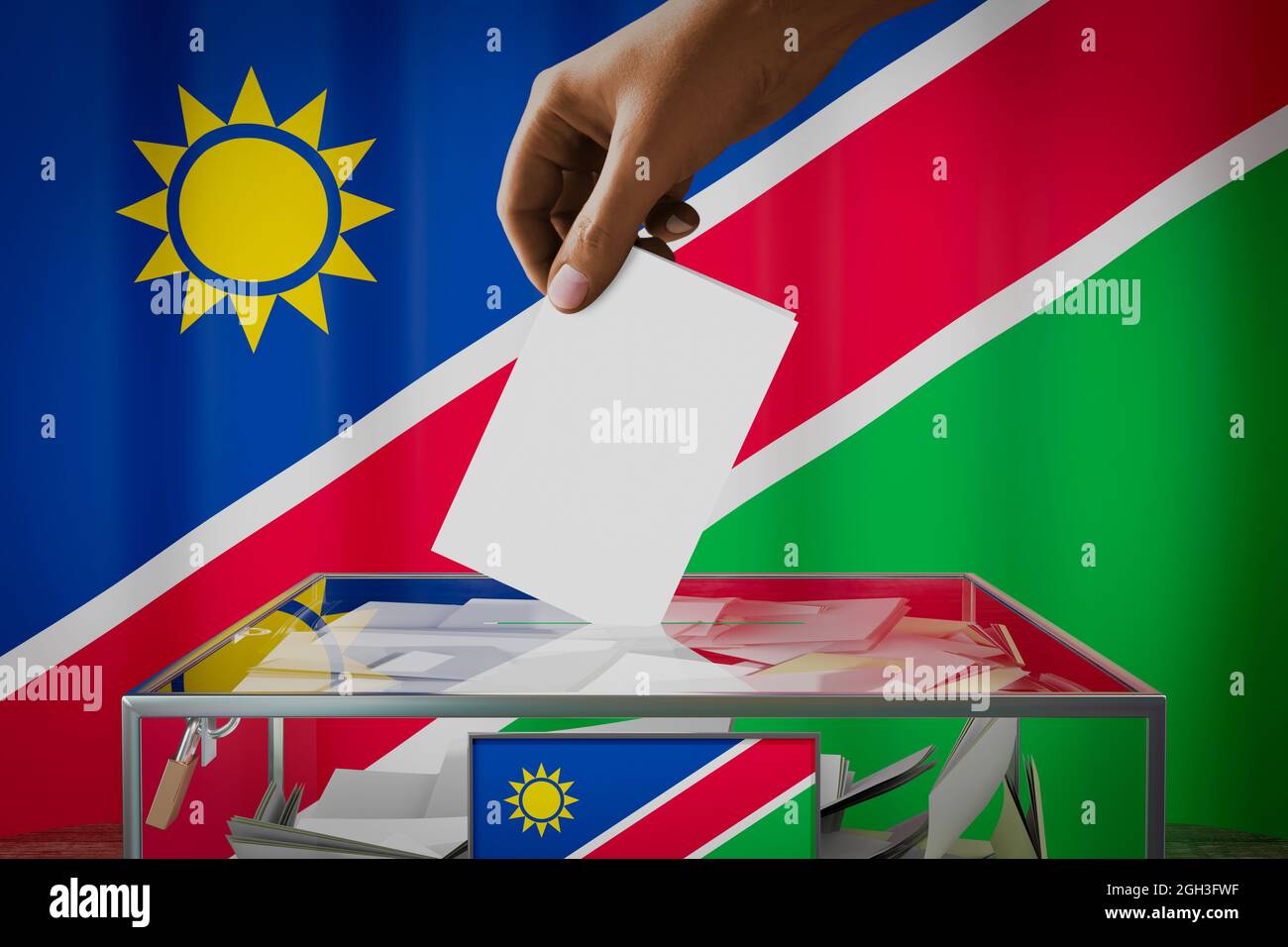 Namibia flag, hand dropping ballot card into a box - voting, election ...