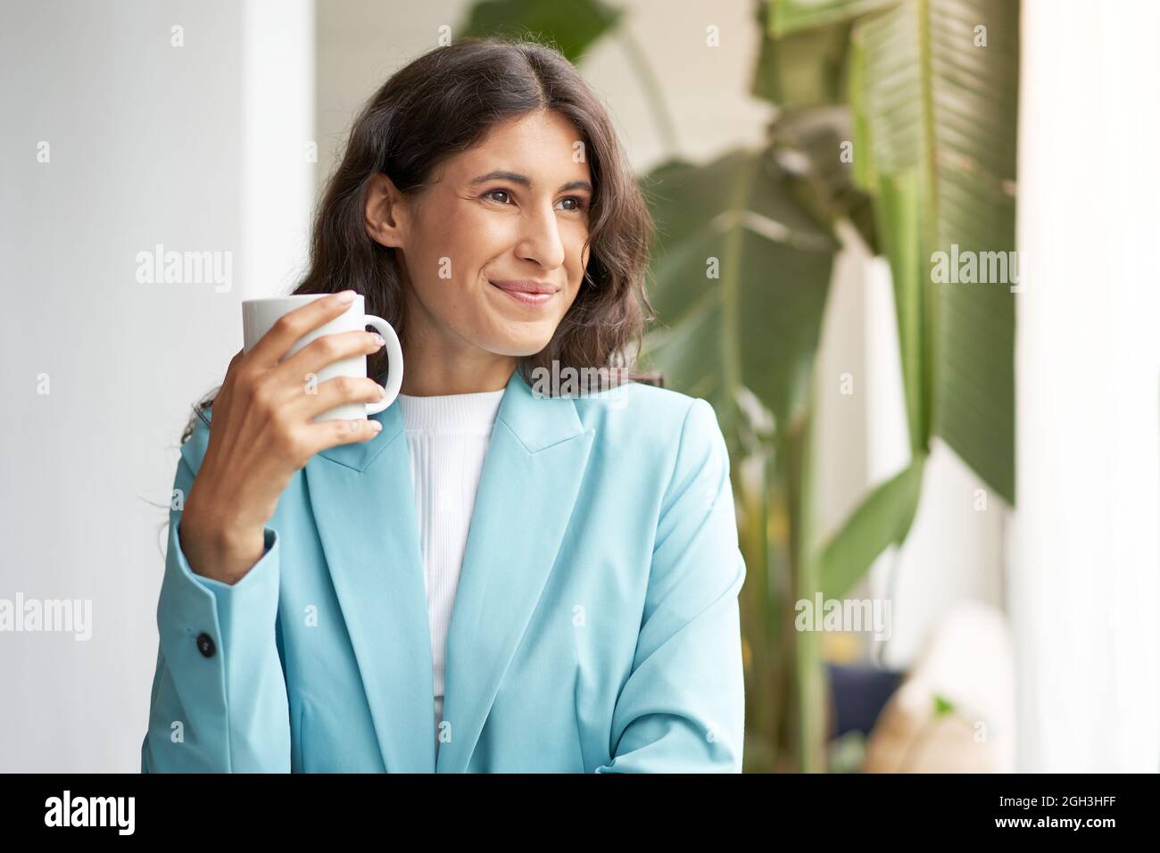 Young smiling Latina business woman, satisfied with a job well done ...