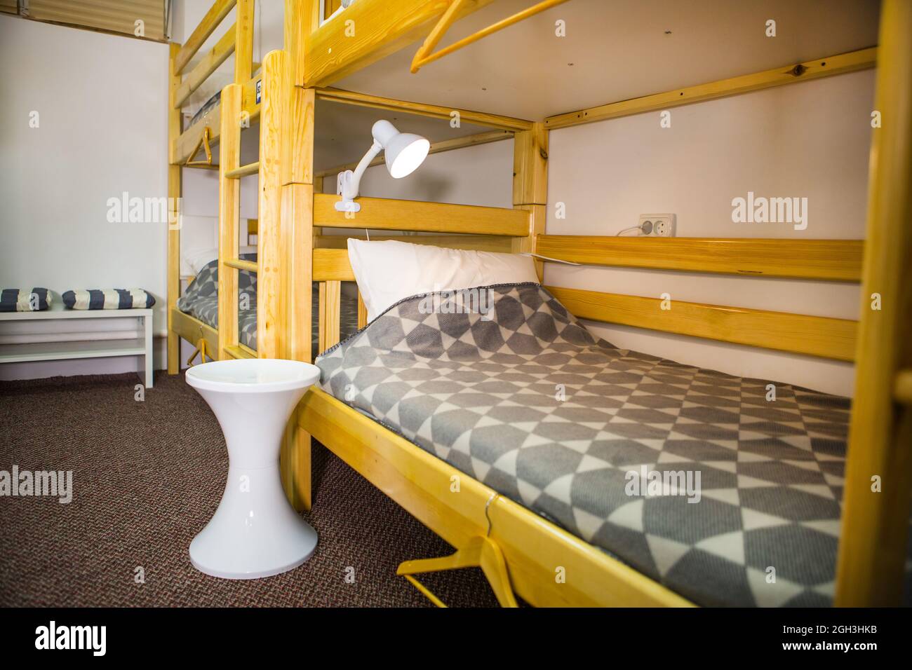 Interior of the hostel bedroom. Hostel with wooden bunk beds Stock ...
