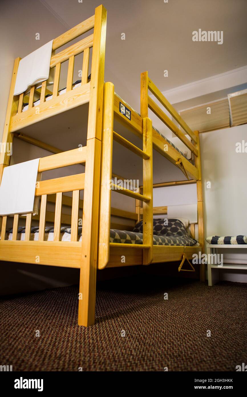 Interior of the hostel bedroom. Hostel with wooden bunk beds Stock ...