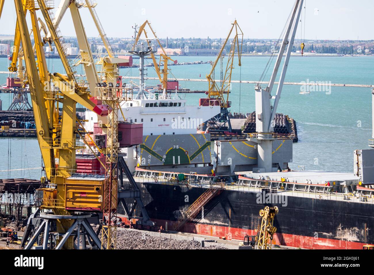 Vessel dry cargo on loading by iron ore, unloading in port. Bulker in ...