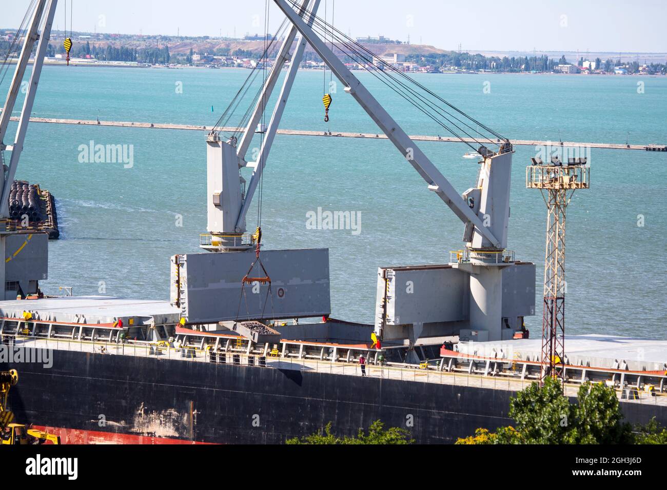 Vessel dry cargo on loading by iron ore, unloading in port. Bulker in ...