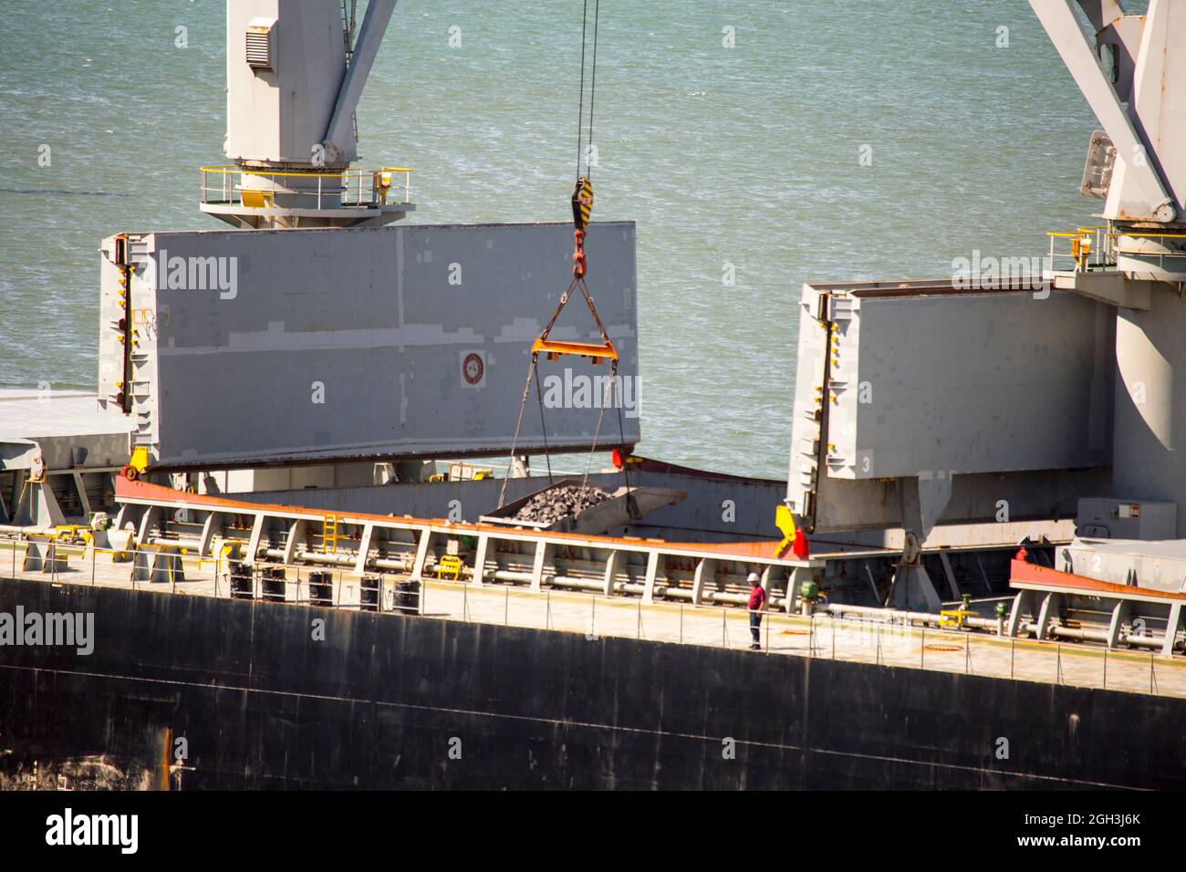 Vessel dry cargo on loading by iron ore, unloading in port. Bulker in ...