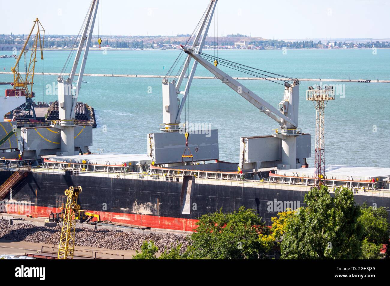 Vessel dry cargo on loading by iron ore, unloading in port. Bulker in ...