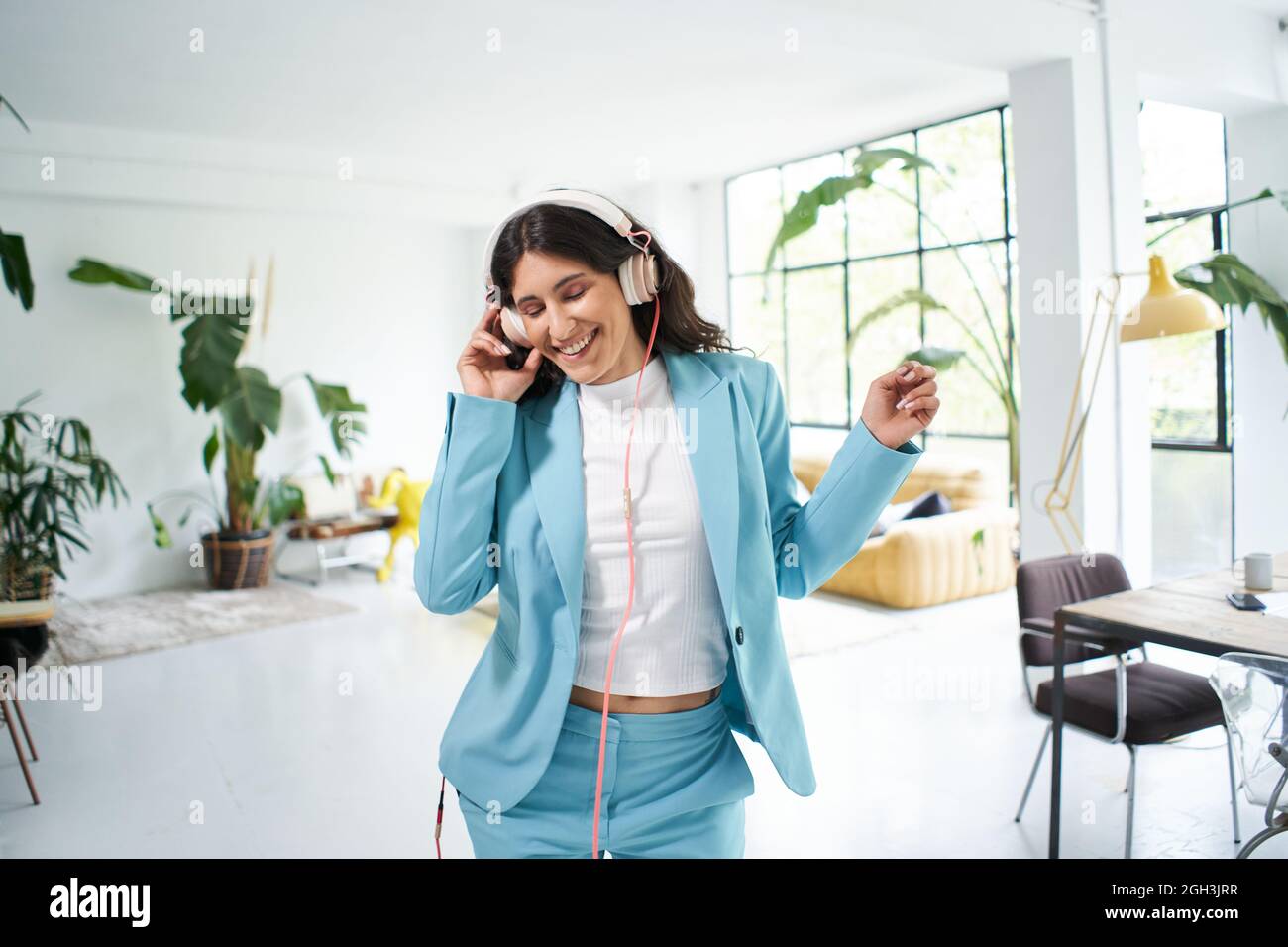 Happy business woman in formal suit dancing motivated celebrating work ...