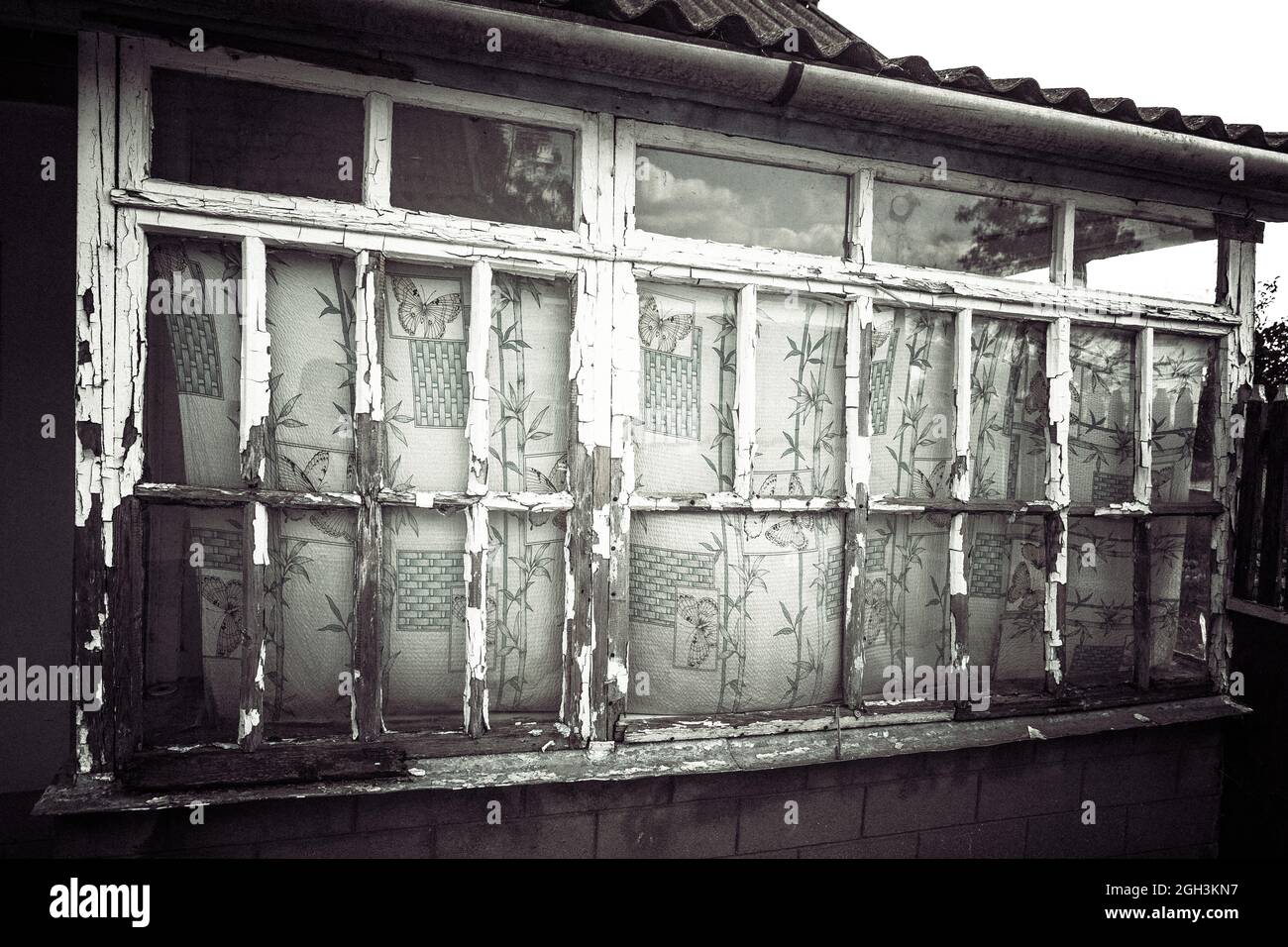 Old windows. Old windows in the wall of an abandoned house. Windows with irradiated frames Stock ...