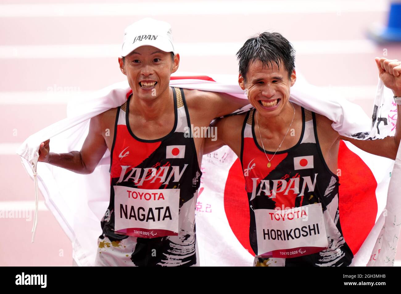 Japan's Tadashi Horikoshi (right) celebrates after crossing the line in ...