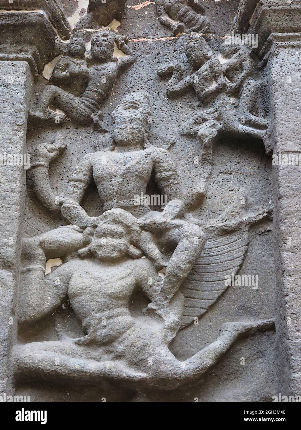 Damaged rock carving of Lord Vishnu, sitting on Garuda, his vehicle ...