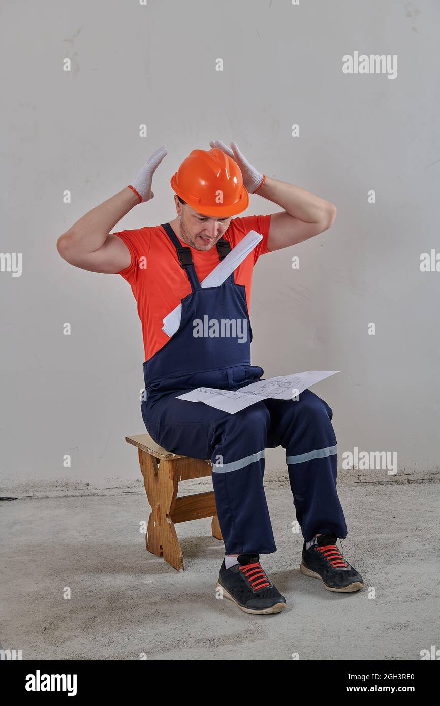 a very stupid engineer examines the blueprints of the project Stock ...