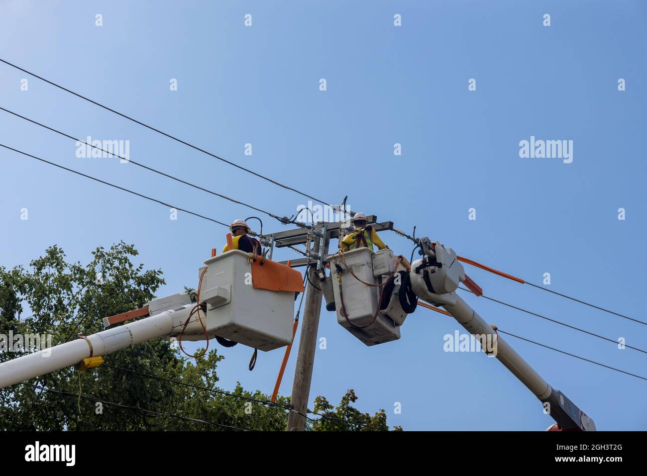 Power electrical lines support servicemen handling damage after ...