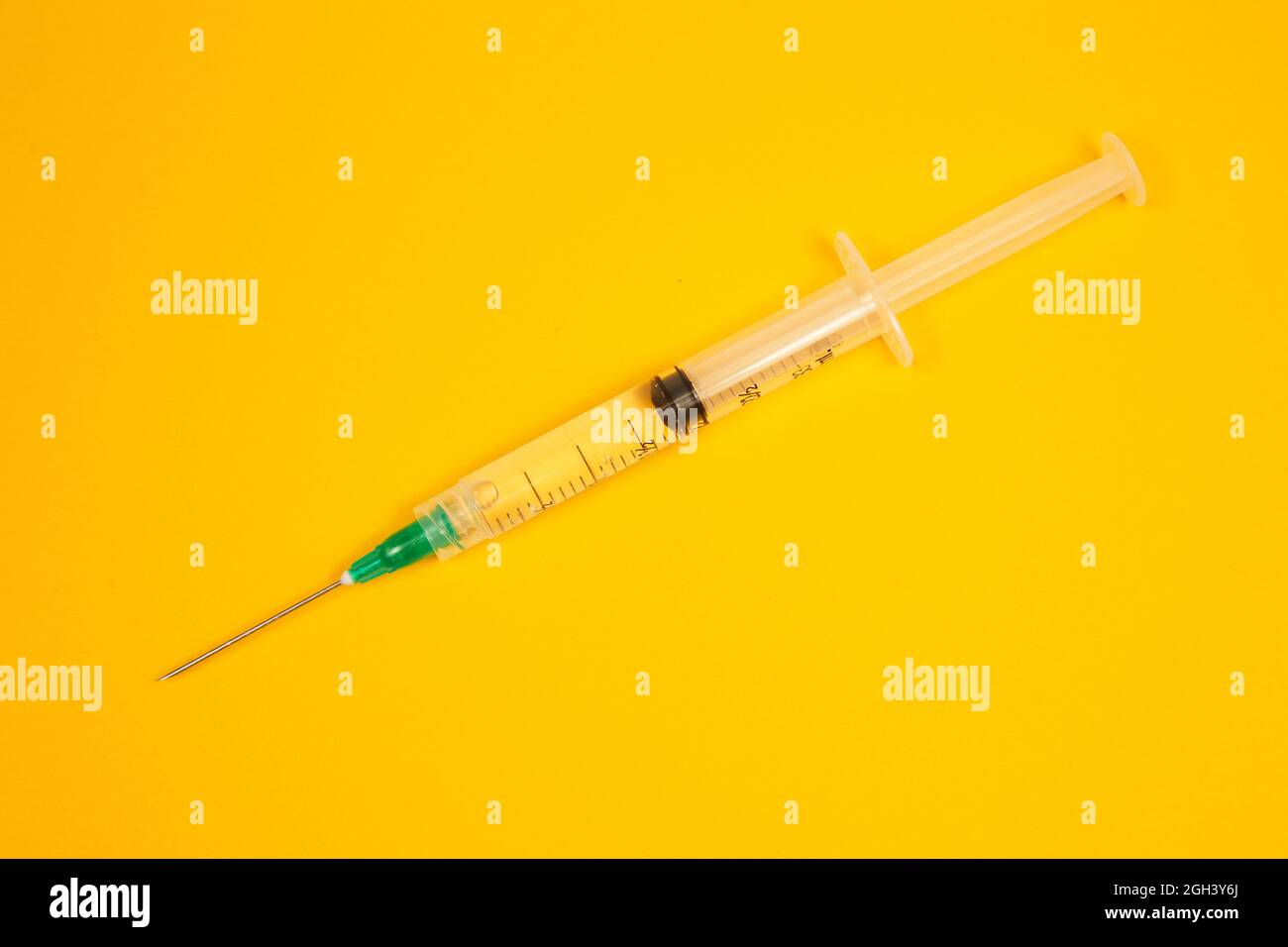 Syringe on yellow background. Healthcare background Stock Photo - Alamy