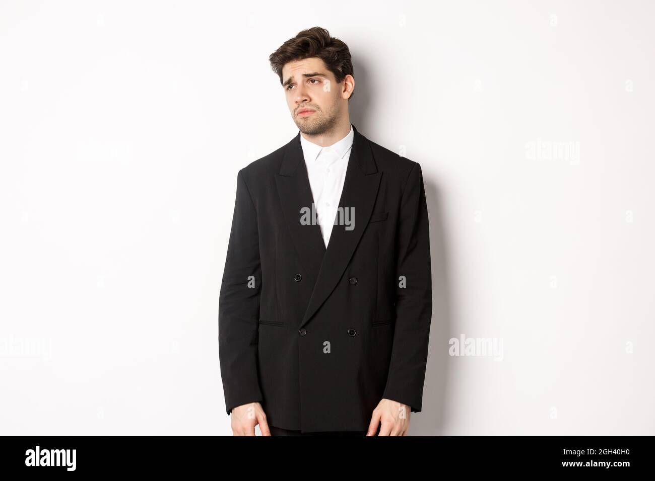 Image of tired man in suit looking left with distressed, gloomy ...
