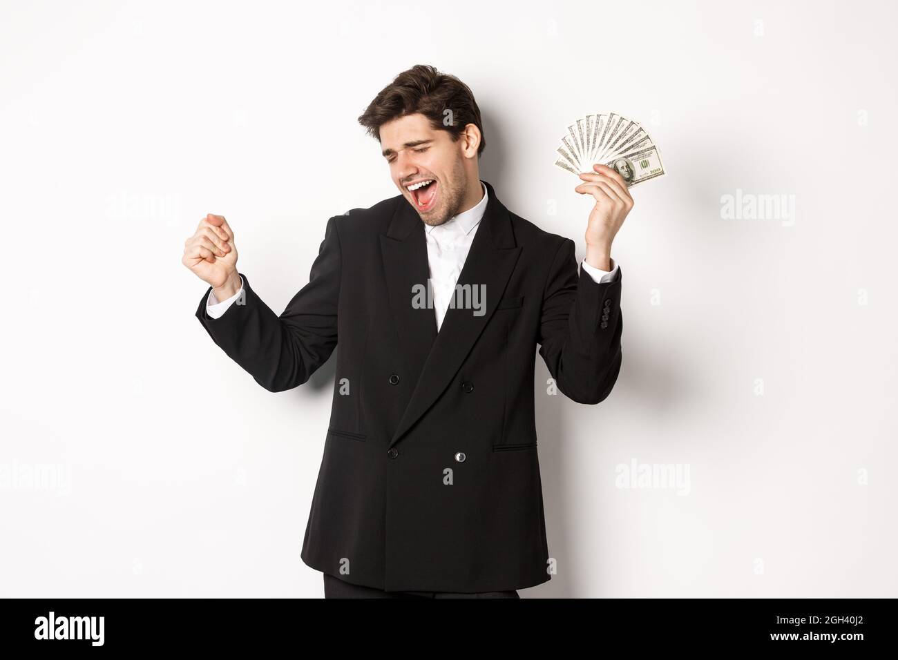 Portrait of handsome and successful businessman in suit, dancing with ...