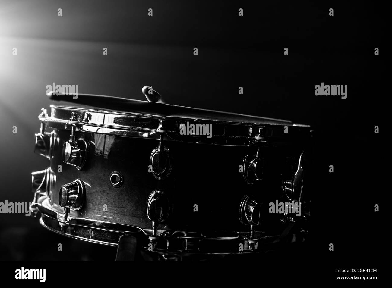 Close-up of a snare drum, percussion instrument on a dark background ...