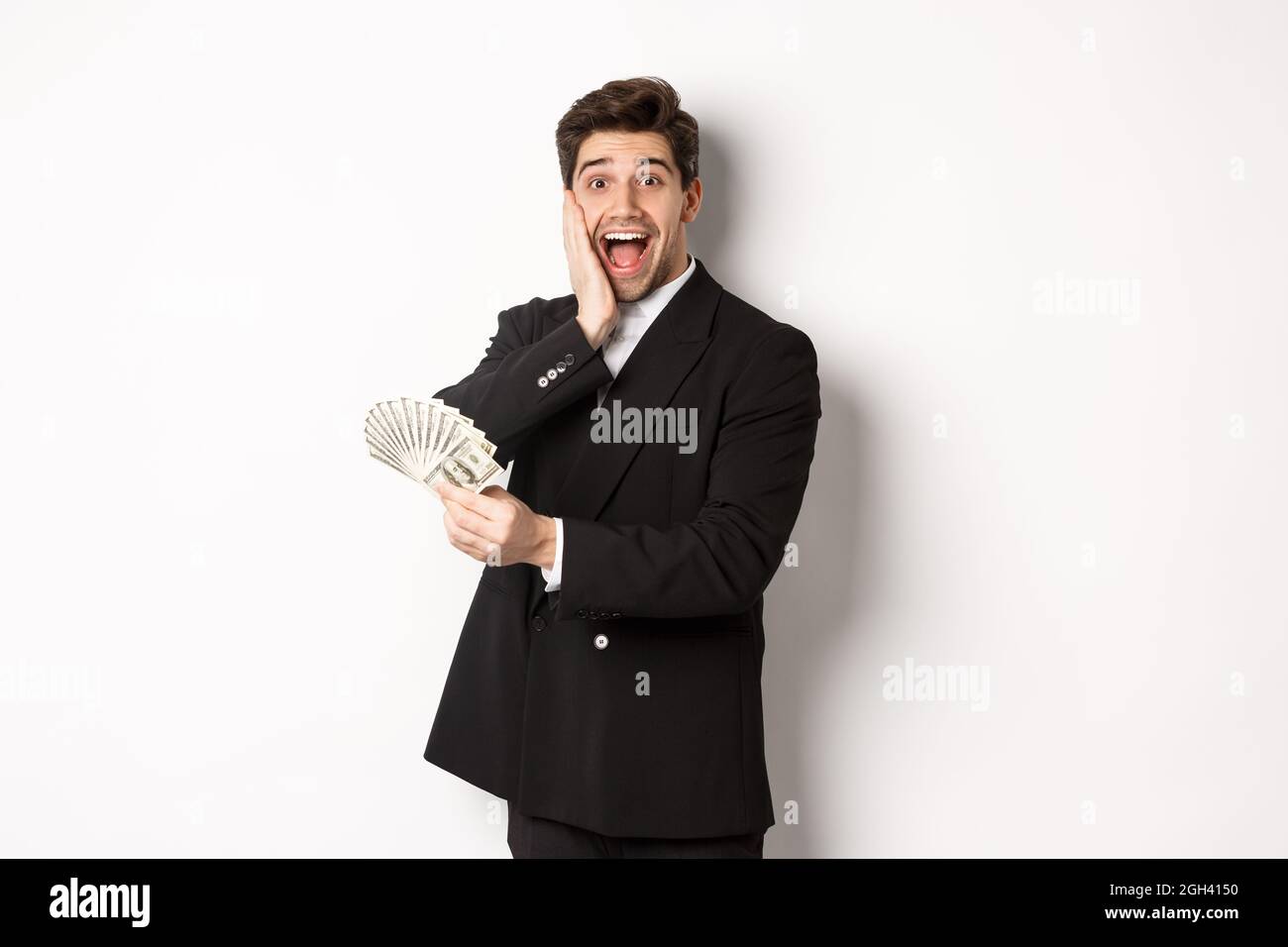 Image of rich and happy man in black suit, winning prize, holding money ...