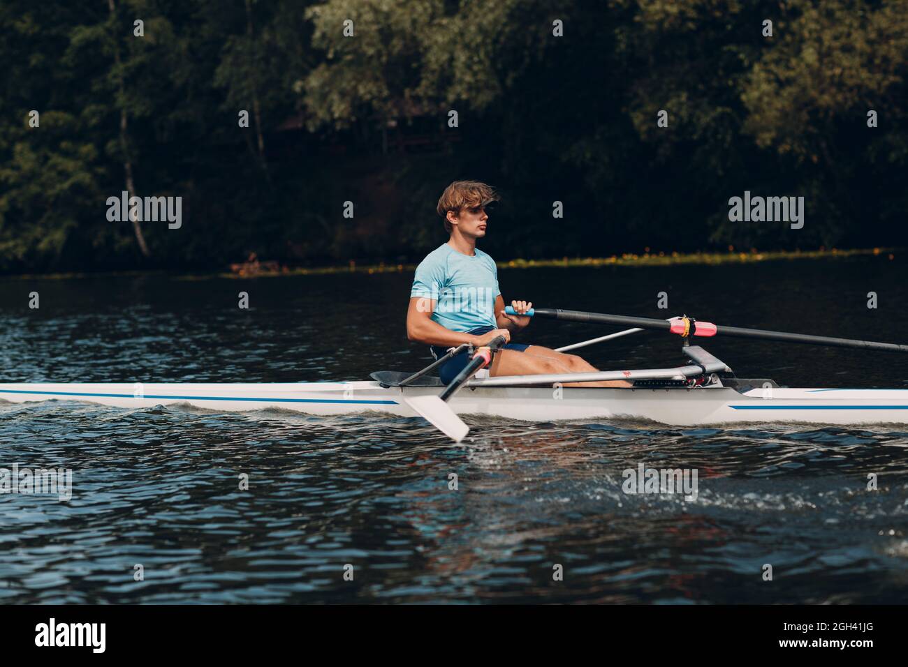 Sportsman single scull man rower rowing technique on boat. Paddle oar ...