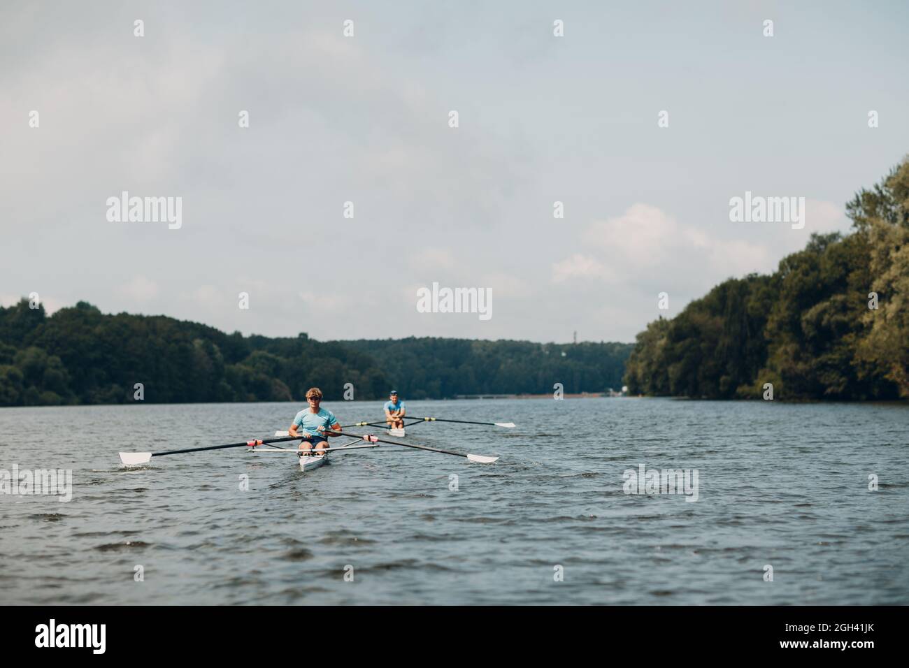 Sportsman single scull man rower rowing on boat Stock Photo - Alamy