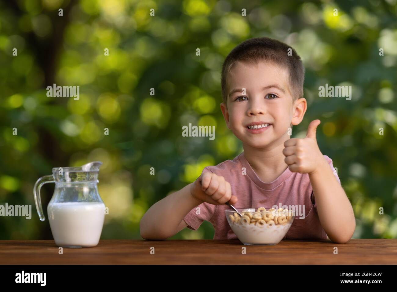 little boy eating corn flakes on breakfast outdoors Stock Photo - Alamy