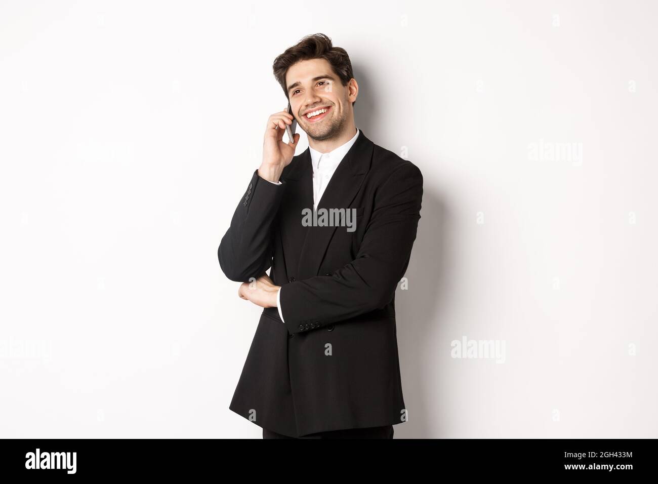 Image of handsome and successful businessman talking on phone, smiling ...