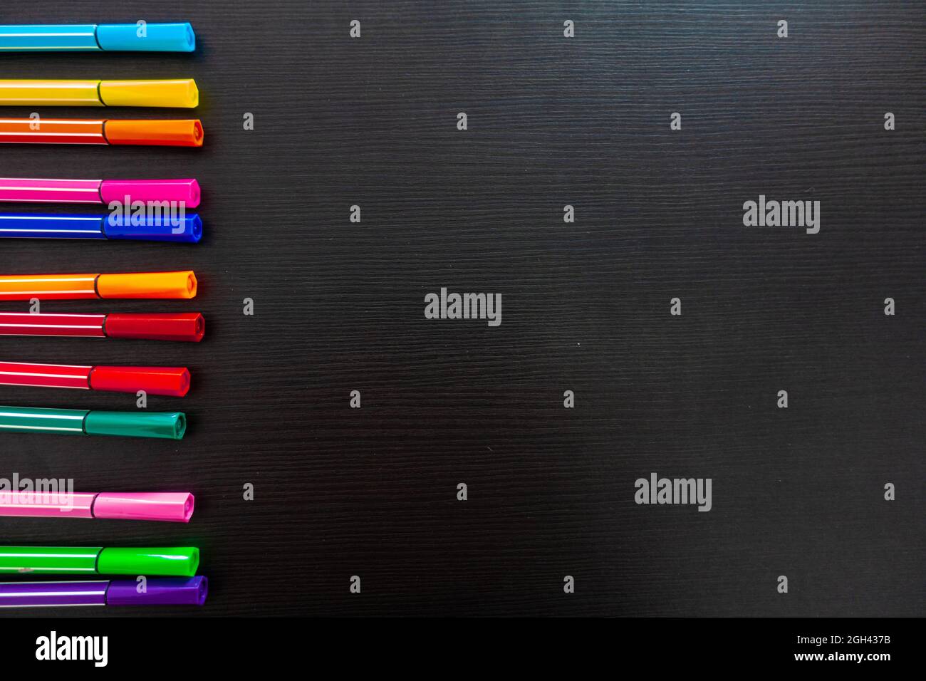 Color pen in variety color on the side on dark brown copy space ...