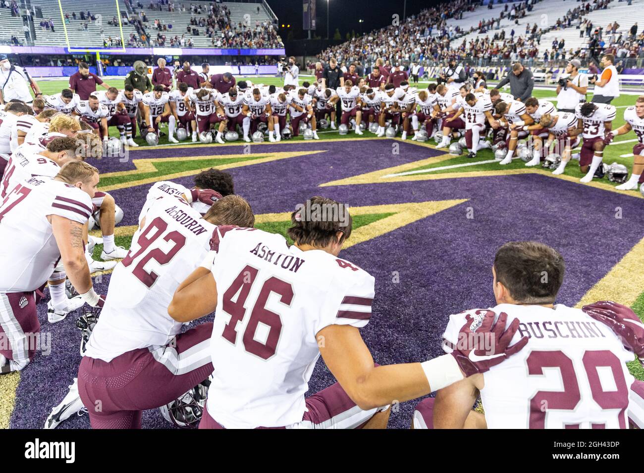 Montana Grizzlies gather around the Washington logo at center field ...