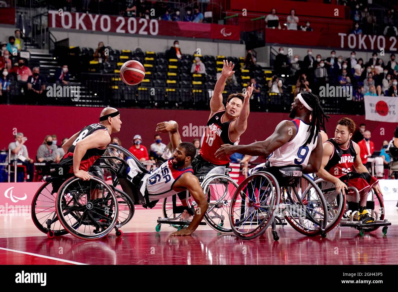 USA's Trevon Jenifer goes over under pressure as Japan's Tetsuya ...