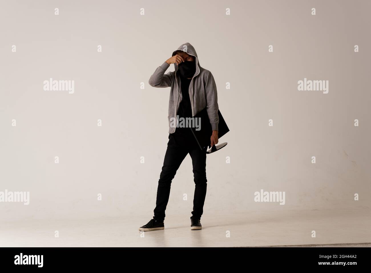 a man with a monitor in his hands steals a computer anonymity Hacker ...